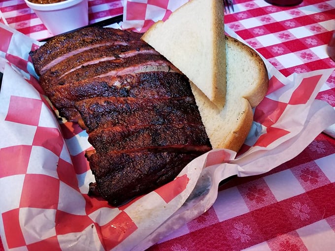 Behold the bark! These ribs have the kind of smoke ring that makes BBQ enthusiasts weak in the knees. The white bread serves as both garnish and sauce-sopping tool.