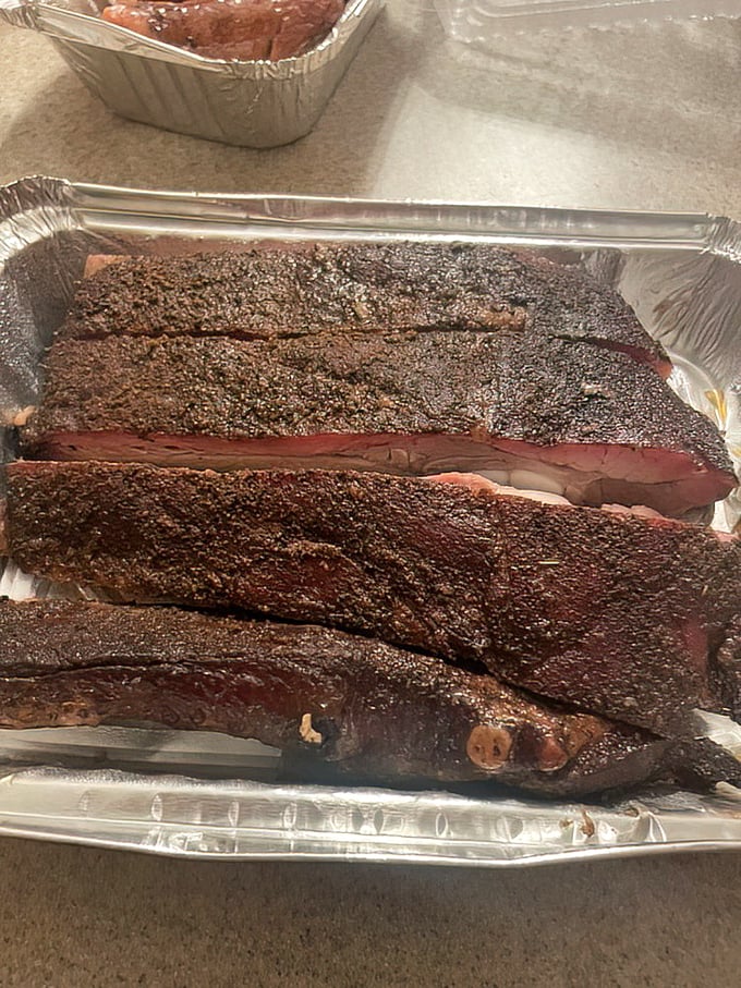 Bark so beautiful it belongs in an art gallery. These ribs showcase that perfect pink smoke ring that BBQ aficionados dream about at night.