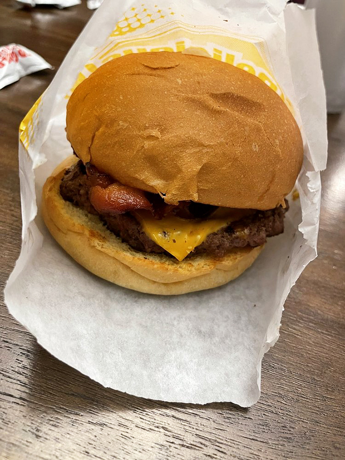 Behold the humble champion of lunch breaks everywhere&mdash;a perfectly grilled cheeseburger with bacon that could make even the most dignified Minnesotan abandon their "nice" demeanor.