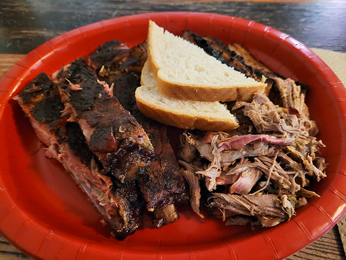 Behold the bark on those ribs! That perfect pink smoke ring isn't just food science&mdash;it's edible poetry. The pulled pork alongside looks ready for its close-up.