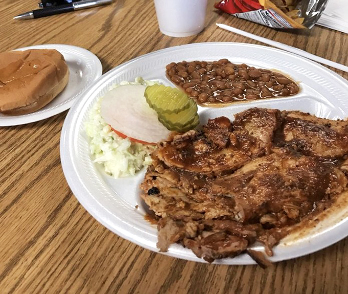 Barbecue nirvana on a plate: smoky pulled pork, beans simmered to perfection, and coleslaw that cuts through the richness like a cool breeze.