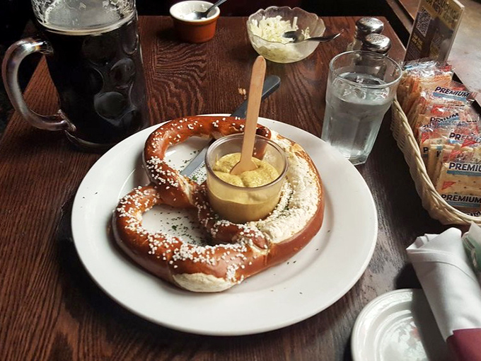 The pretzel arrives like royalty on its own special throne, surrounded by dipping courtiers ready to enhance its already magnificent presence.
