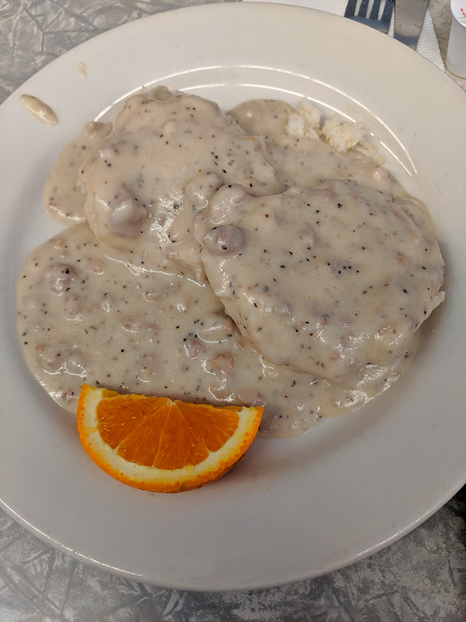 Biscuits swimming in creamy, pepper-flecked gravy with a citrus sidekick&mdash;proof that happiness can indeed be served on a plate.