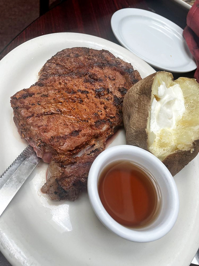 Blackened prime rib that's wearing its char like a badge of honor, alongside a baked potato that's practically begging to be your dinner date.