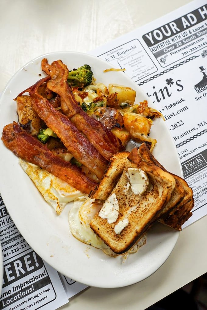Breakfast architecture at its finest&mdash;perfectly cooked eggs nestled against crispy bacon with a supporting cast of seasoned home fries and buttery toast.