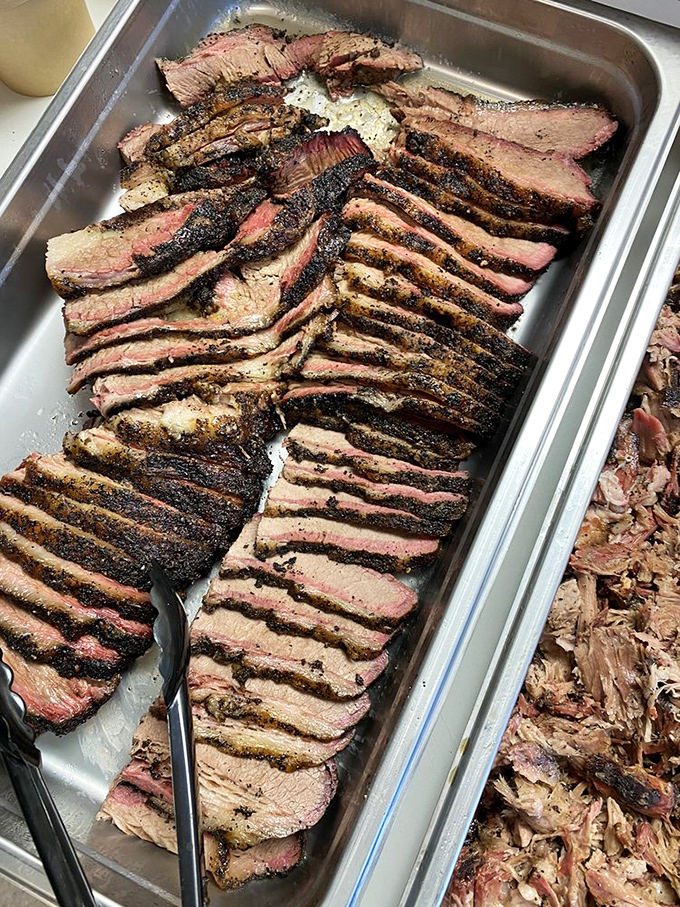Behold the holy grail of barbecue: perfectly sliced brisket with that textbook smoke ring and bark that makes meat lovers weak at the knees.