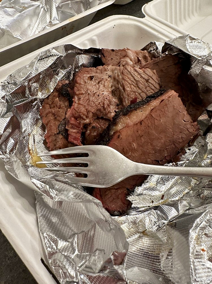 Brisket so tender it practically surrenders to your fork. Each slice bears the hallmark pink smoke ring&mdash;nature's way of saying "you're welcome."