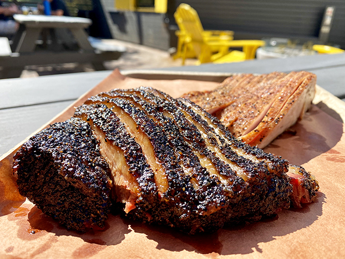 Behold the holy grail of barbecue: perfectly smoked brisket with that coveted pink ring and pepper-crusted bark that shatters like carnivorous candy.