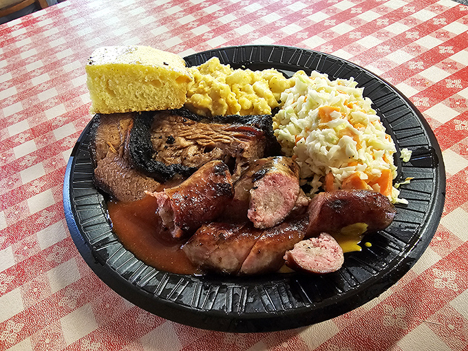 Barbecue nirvana on a plate: brisket with that perfect smoke ring, sausage with snap, and sides that don't play second fiddle. 