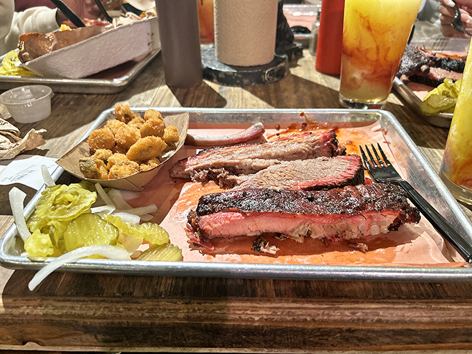 Brisket with a bark so perfect it should be in a museum. Those pickles aren't just garnish—they're the acid jazz in this meaty symphony.