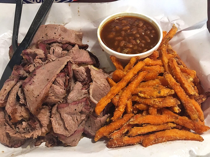 Sliced brisket with that telltale pink smoke ring, sweet potato fries, and beans rich enough to be a meal themselves&mdash;the holy trinity of smokehouse bliss.