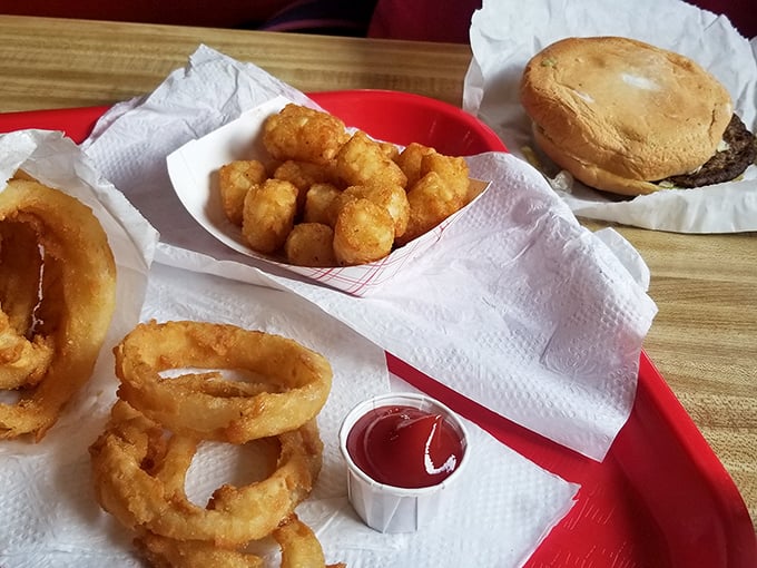 Golden-fried perfection on a tray. These onion rings and tots aren't just sides, they're the supporting actors who sometimes steal the show.