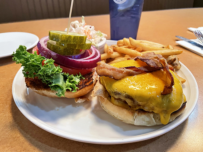 This isn't just a burger; it's architecture. The melted cheese cascading down like a yellow waterfall makes resistance utterly futile.
