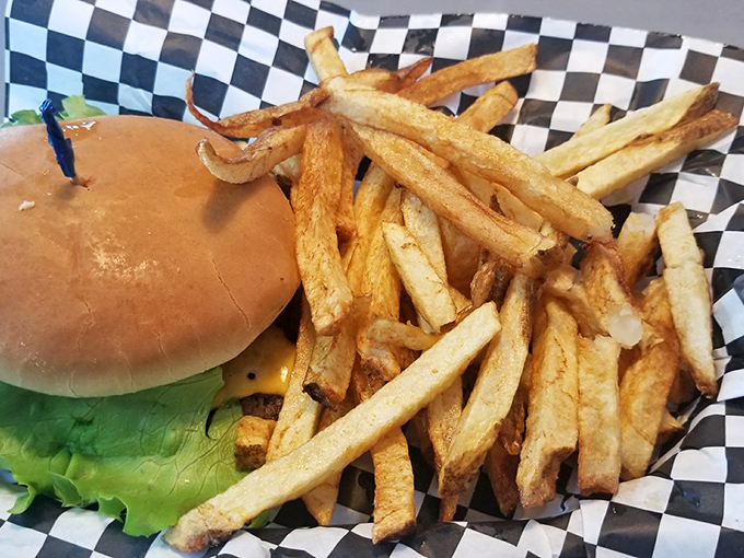 This isn't just lunch—it's edible nostalgia. Hand-cut fries and a perfectly grilled burger on checkered paper: America's most perfect pairing.