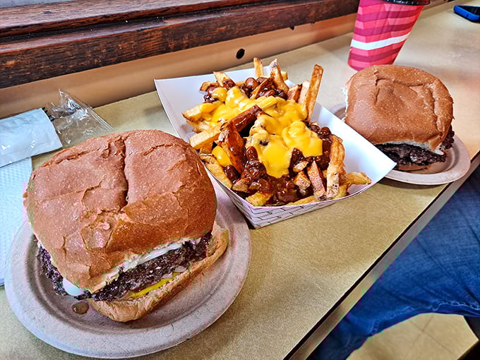 Comfort food trifecta: Two perfectly grilled cheeseburgers flanking a basket of cheese fries that whispers, "Diet plans were made to be broken."