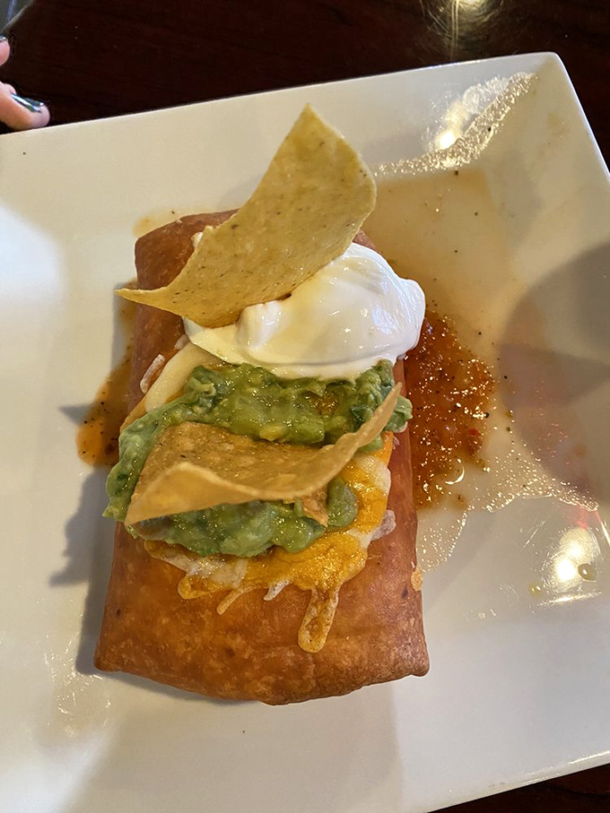 The star of the show in all its golden-fried glory&mdash;a chimichanga topped with guacamole and sour cream that makes calorie counting seem utterly pointless.