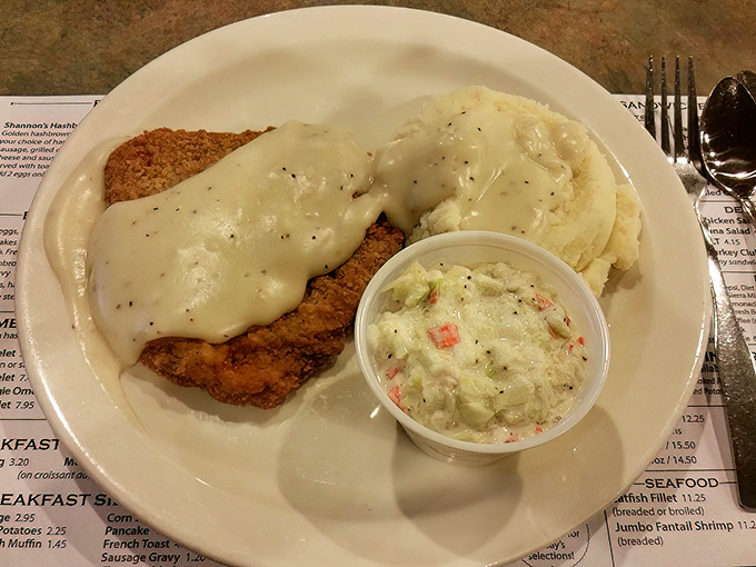 Behold the star attraction &ndash; chicken fried steak smothered in peppery gravy alongside creamy mashed potatoes and coleslaw that grandma would approve of.