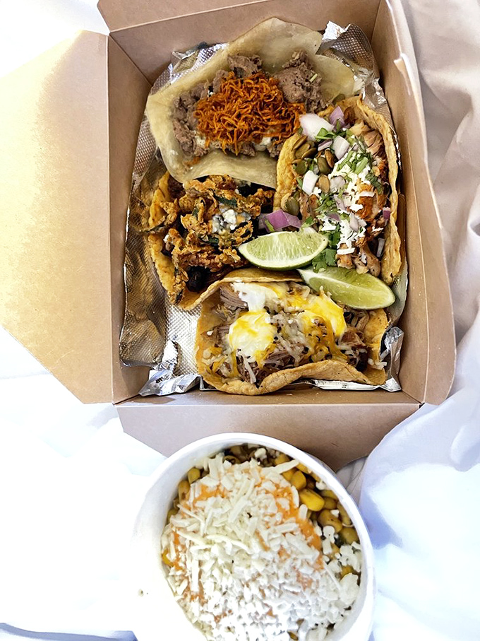 Behold the humble cardboard container, elevated to art form. These tacos aren't just arranged&mdash;they're composed, with each garnish playing its perfect role.