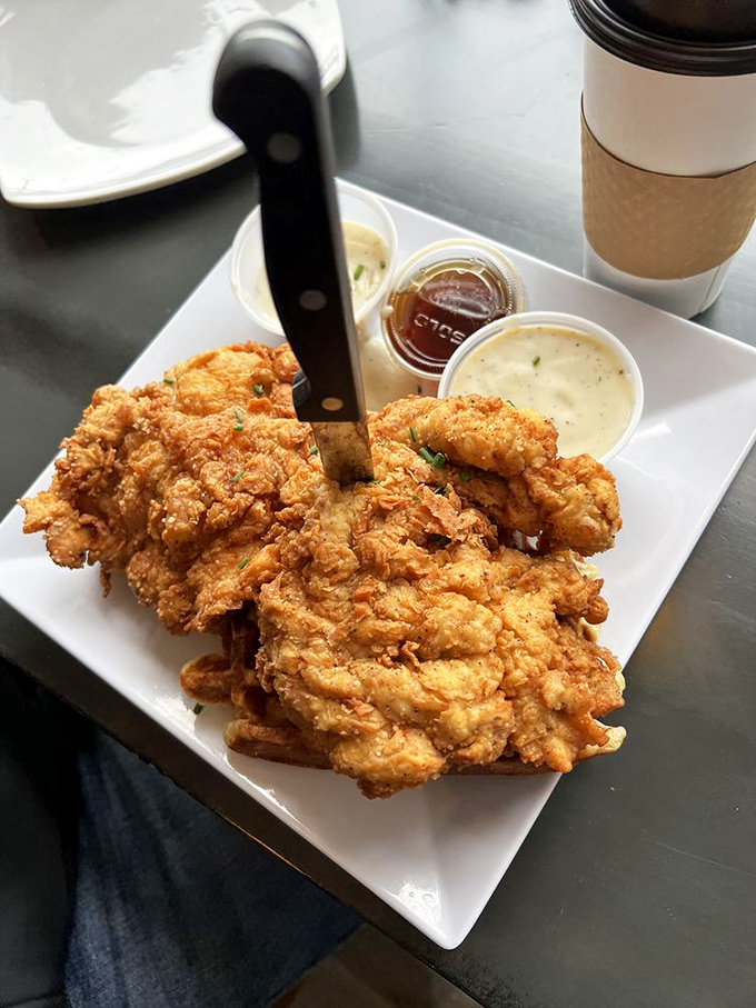 Golden-fried chicken so crispy you can hear it from the photo, served with dipping sauces that make condiment commitment issues completely understandable.