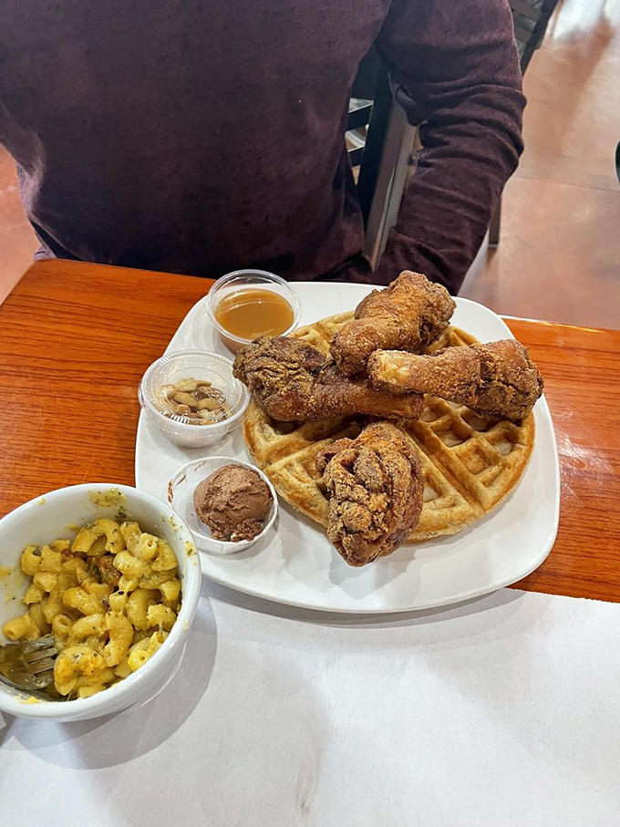 Golden fried chicken perched atop a perfect waffle with a side of mac and cheese – a trio so harmonious they could release a platinum album.