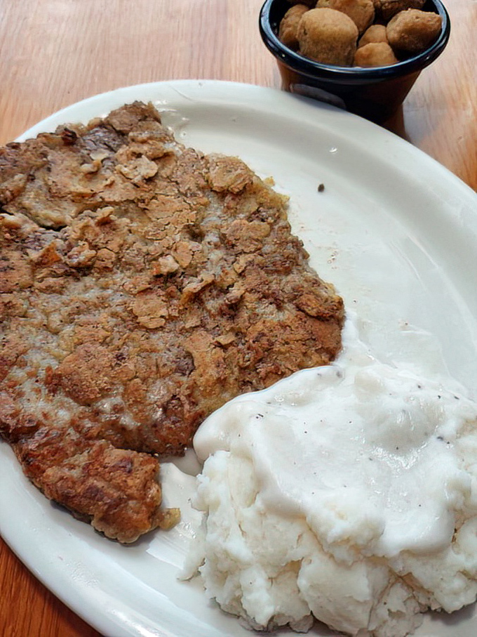 Behold the star of the show &ndash; a chicken fried steak with a golden crust that crackles with each bite, nestled beside creamy mashed potatoes.
