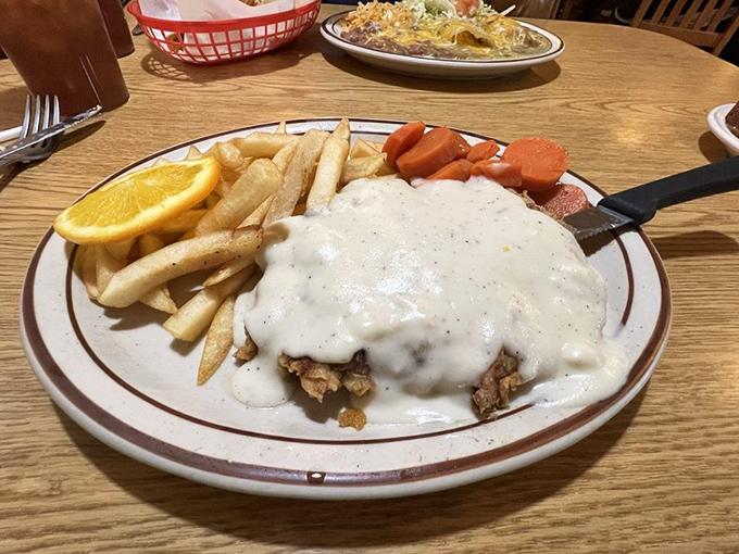 Behold the star of the show: chicken fried steak swimming in pepper-flecked country gravy with fries and carrots standing by for moral support.