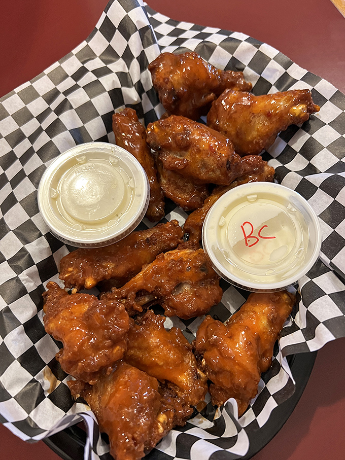 These wings aren't just cooked, they're transformed&mdash;glistening with sauce that demands you keep a napkin handy and your dignity at the door.