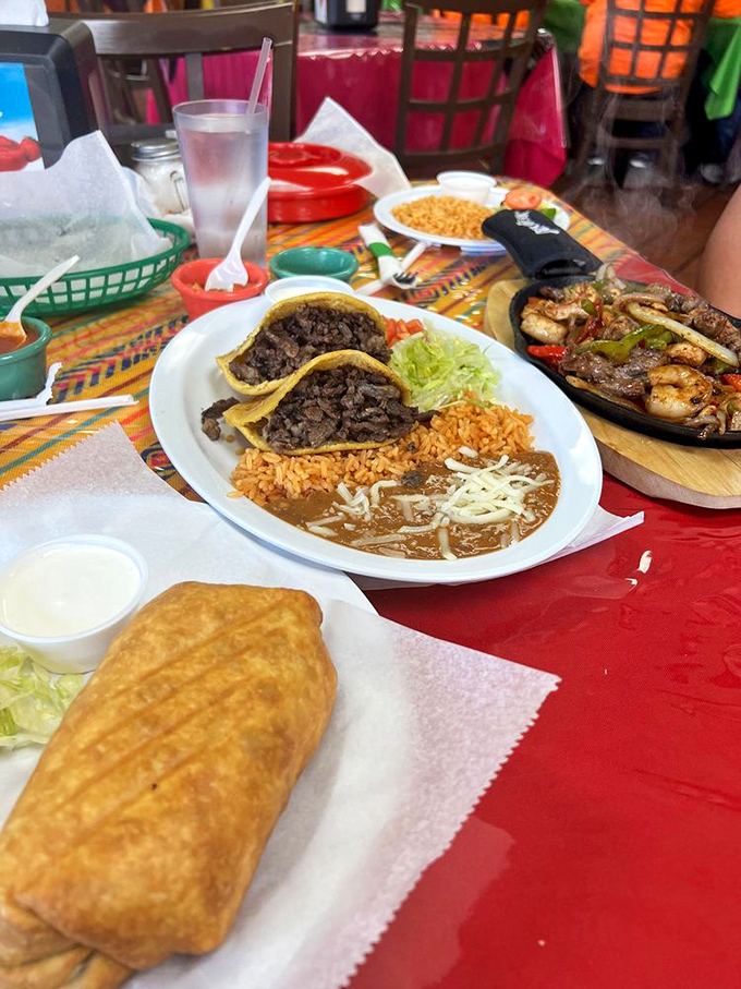 A table spread that makes decision-making impossible. That sizzling fajita platter on the right is performing its own delicious soundtrack.