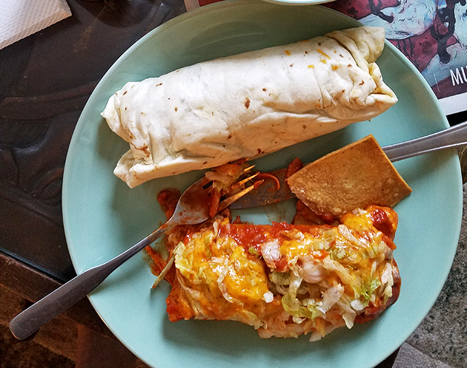This plate tells a tale of two textures—a burrito's pillowy embrace alongside a chimichanga's crispy rebellion. The fork marks show someone couldn't wait.