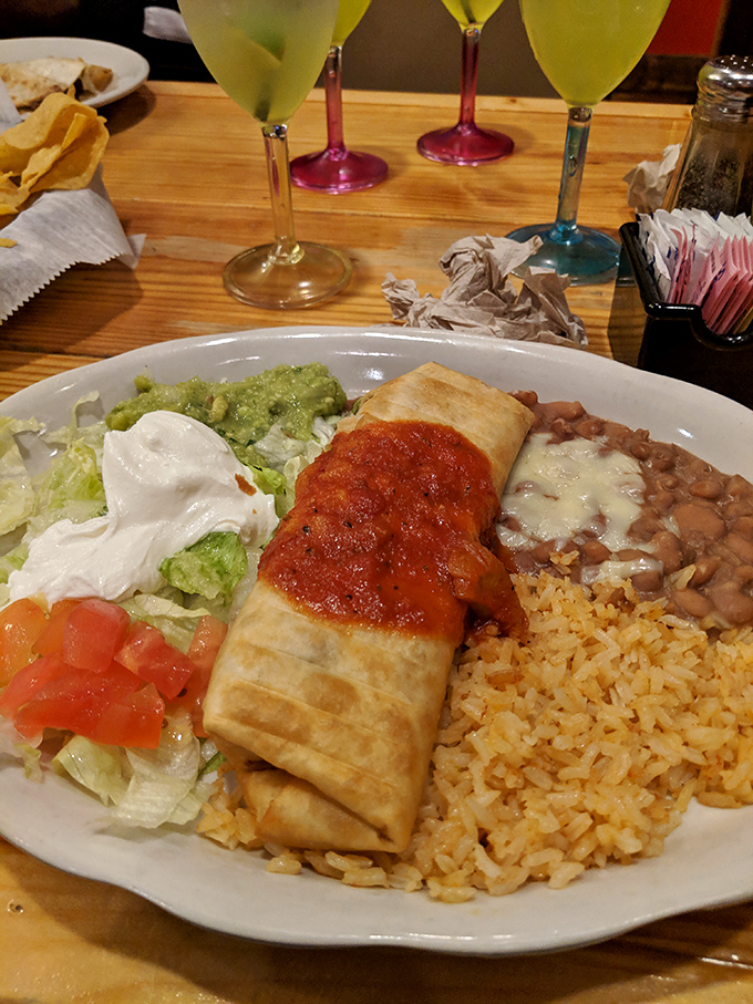 This chimichanga isn't just fried, it's transformed &ndash; a golden-brown masterpiece accompanied by the holy trinity of rice, beans, and fresh toppings. 