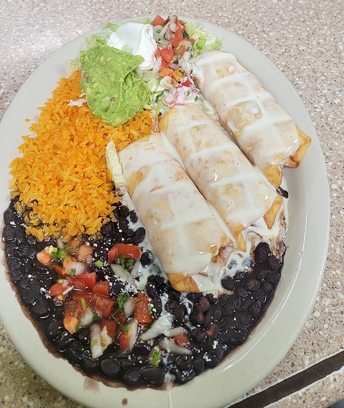 Behold the chimichanga in its natural habitat &ndash; gloriously golden, blanketed in cheese sauce, and practically begging to be the star of your Instagram feed. 