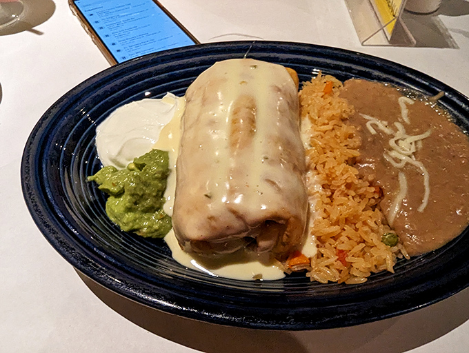 This chimichanga isn't just dinner&mdash;it's a commitment. Golden-fried perfection smothered in queso with sides that refuse to be overshadowed.