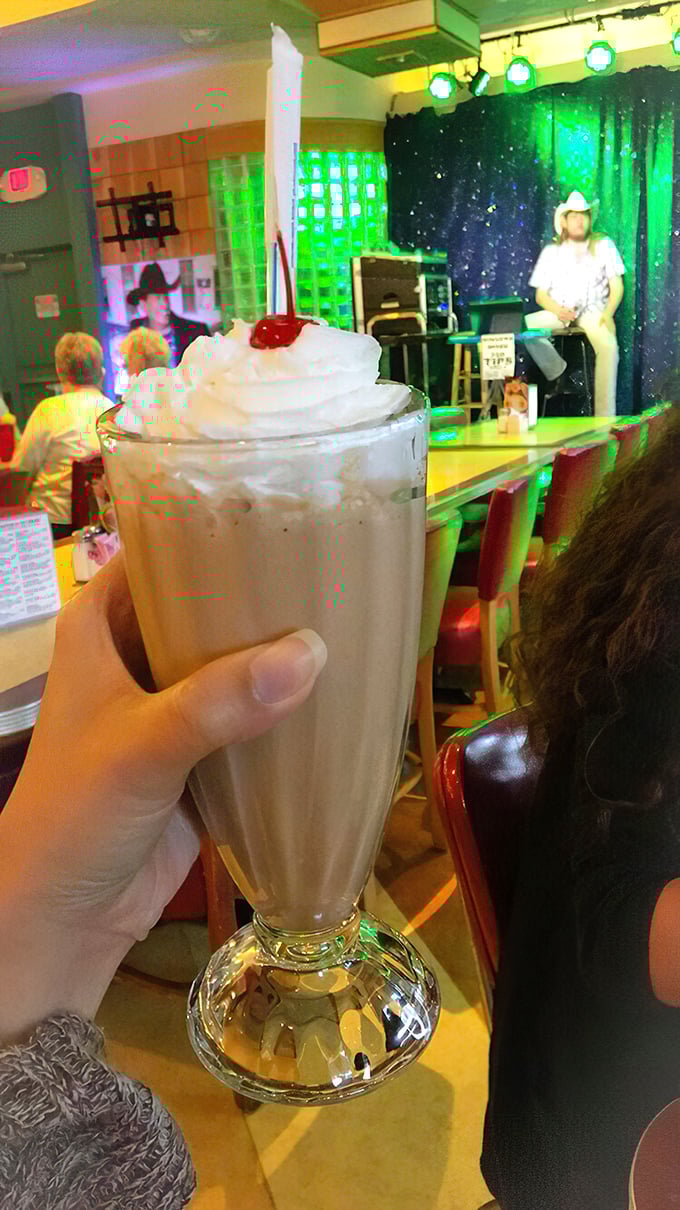 That's not just a milkshake—it's a frothy monument to dairy perfection, tall enough to have its own zip code and thick enough to require serious straw commitment.