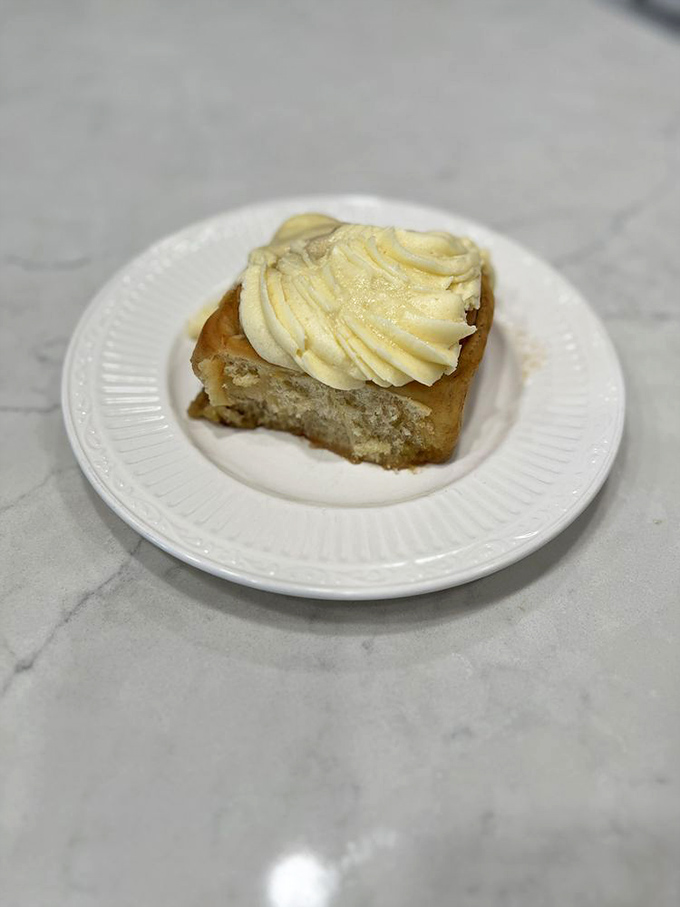 The humble square of heaven that launched a thousand road trips. This cinnamon roll's cream cheese frosting melts into warm, spiced perfection.