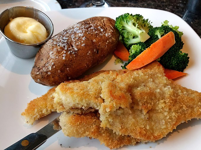 Golden-fried perfection meets garden-fresh veggies. That baked potato isn't just a side&mdash;it's the perfect companion for a seafood adventure.