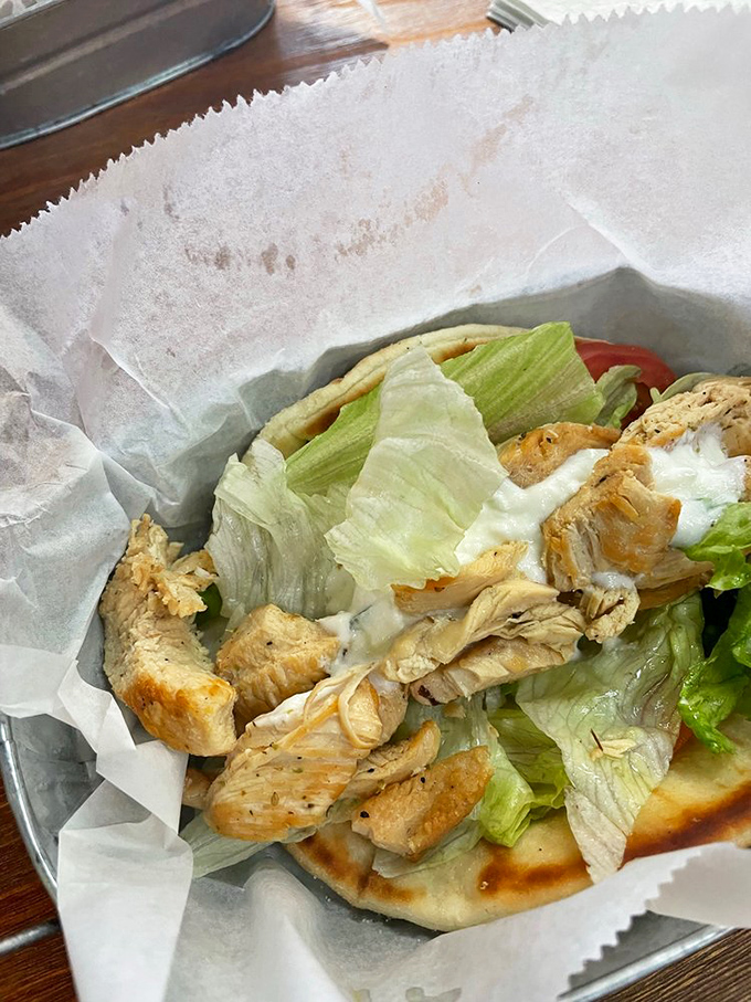This isn't just a chicken gyro&mdash;it's a masterclass in simplicity. Tender meat, crisp lettuce, and that tzatziki sauce that dreams are made of.
