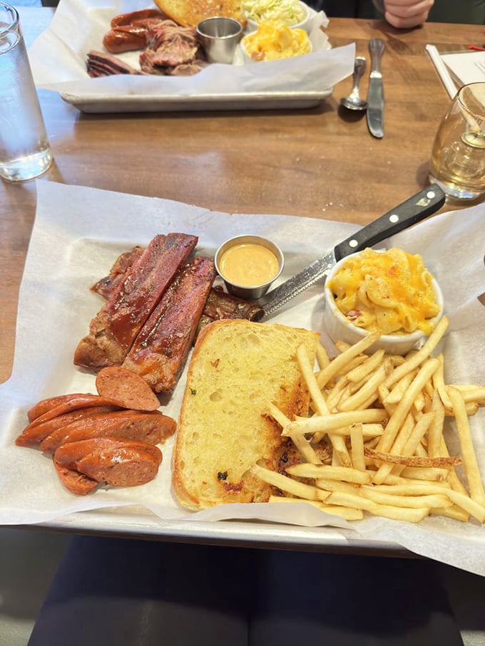 Meat symphony on butcher paper &ndash; the universal language of serious barbecue. Those ribs have the perfect bend that BBQ judges dream about.