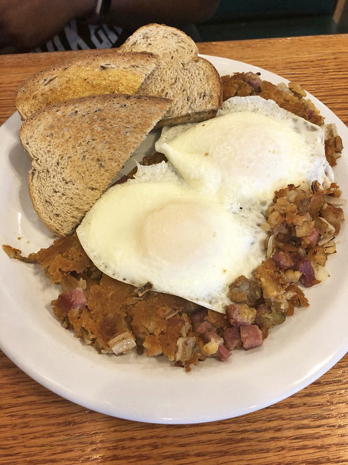 Eggs perched atop a golden throne of corned beef hash—the breakfast equivalent of finding front-row concert tickets in your coat pocket.
