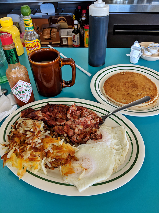 Breakfast nirvana achieved: crispy hash browns, perfectly scrambled eggs, and corned beef hash that would make your cardiologist wince but your soul sing.