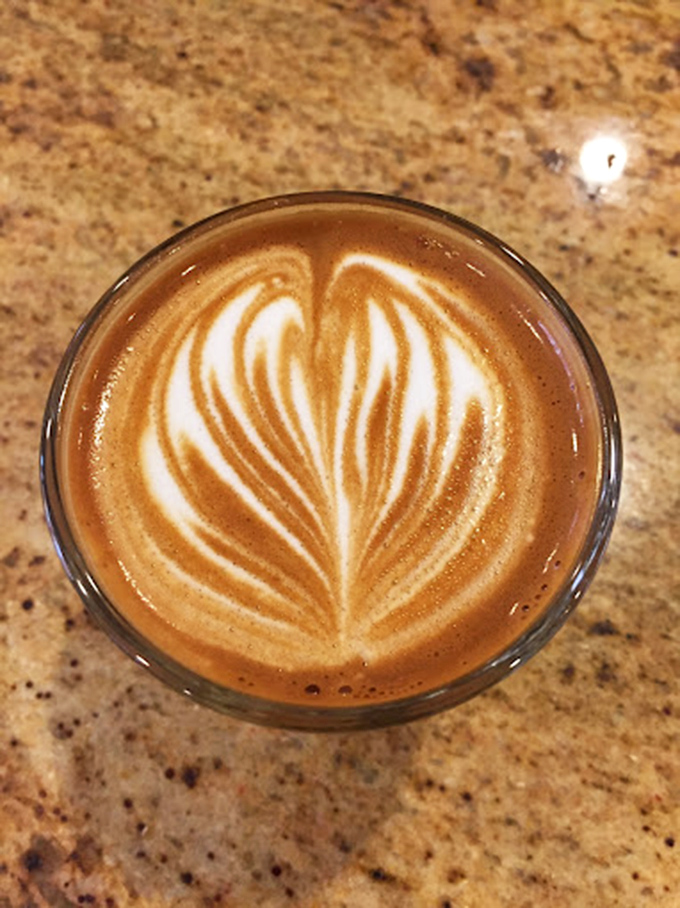 Latte art so perfect it belongs in a museum, not just your stomach. This rosetta pattern whispers, "Take a photo before you sip &ndash; permission granted."