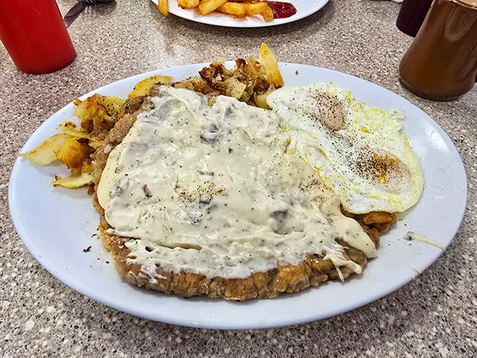 Ladies and gentlemen, I present to you the holy grail of diner cuisine: the country chicken fried steak. It's a crispy, creamy masterpiece that could make a vegetarian weep with temptation.