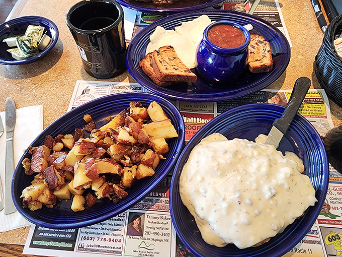 Country fried steak swimming in creamy gravy alongside home fries that look like they've been practicing their crispy-to-tender ratio for decades.
