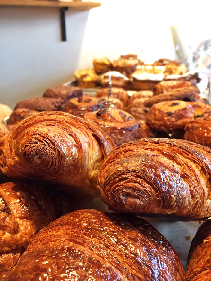 The croissant motherlode! These golden treasures with their honeycomb interiors might make you temporarily forget your own name between bites.