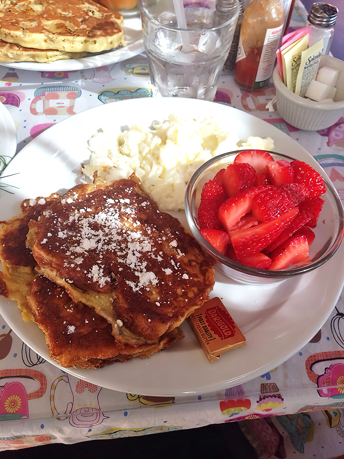 French toast that's dressed better than most people at brunch, complete with powdered sugar "snow" and a berry sidekick.