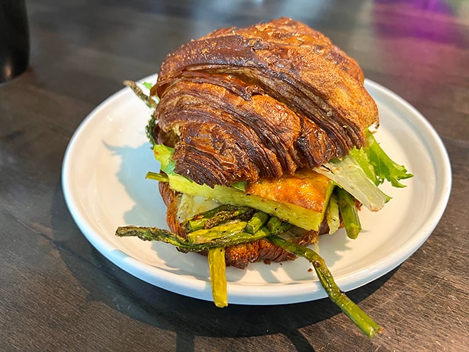 This isn't just a sandwich&mdash;it's architecture you can eat. Layers of vegetables nestled between a croissant so perfectly bronzed it deserves its own trophy.