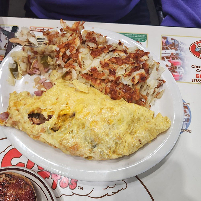 Not so much an omelet as an architectural achievement. The Denver version comes with enough hash browns to feed a small hiking expedition.