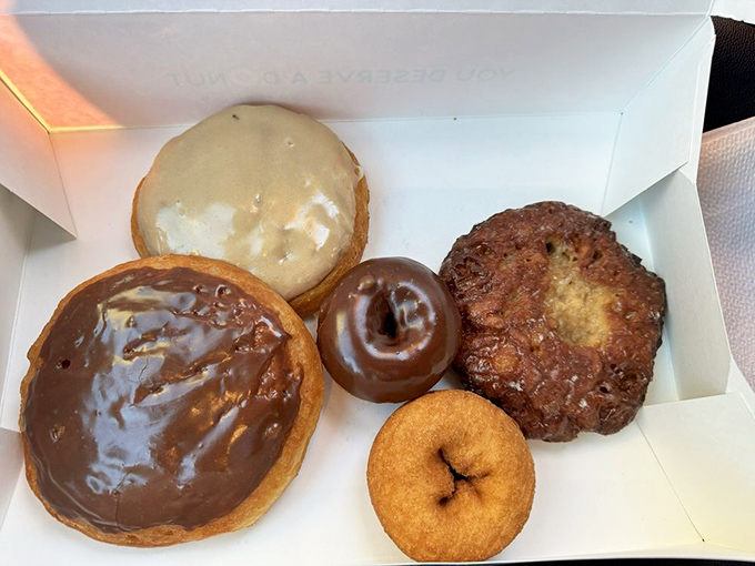 Behold the dream team of breakfast indulgence. That apple fritter on the right isn't just a donut&mdash;it's architecture, sculpture, and pure joy.