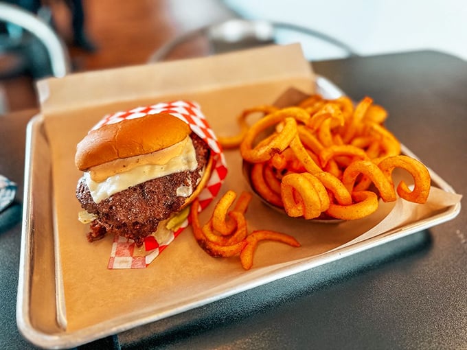 This isn't just a burger, it's edible Americana—juicy patty, melted cheese, and those gloriously golden curly fries that demand to be savored.