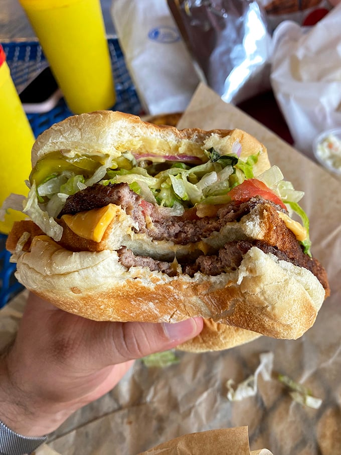 This isn't just a burger; it's architecture in food form. The perfect stack of beef, cheese, and fresh toppings that makes you want to high-five the cook.