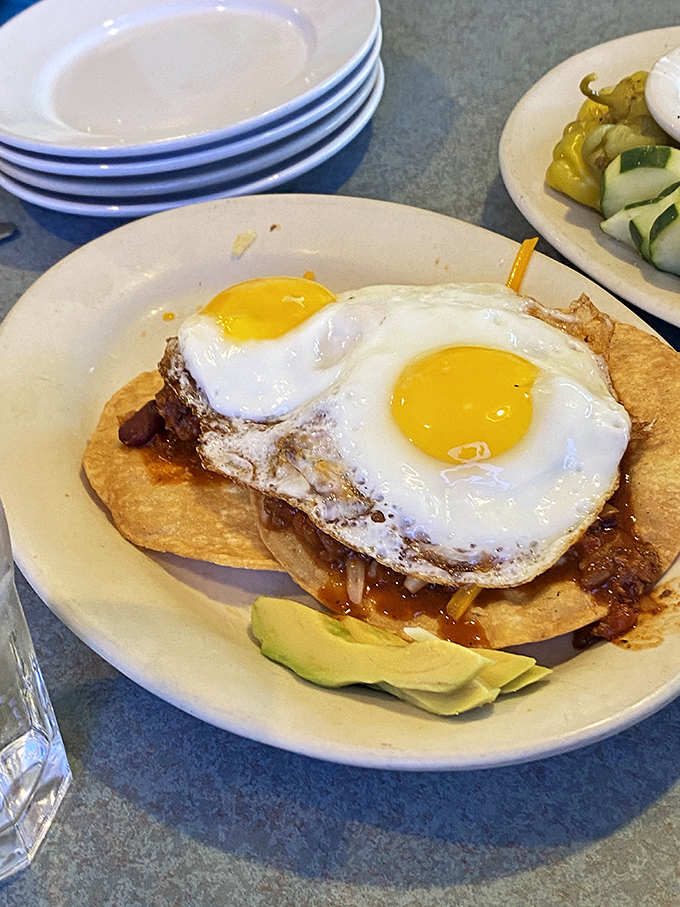 Breakfast goes south of the border with this tortilla masterpiece topped with perfectly sunny-side-up eggs and avocado – morning sunshine on a plate.